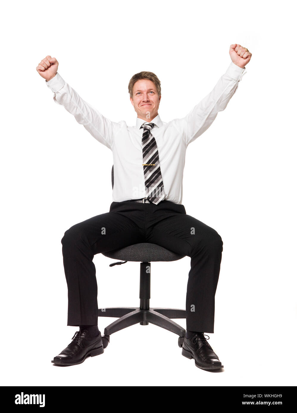 Happy man siting on a office chair Stock Photo - Alamy