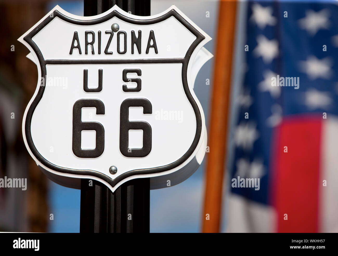 Route 66 sign on side of road with American flag Stock Photo - Alamy