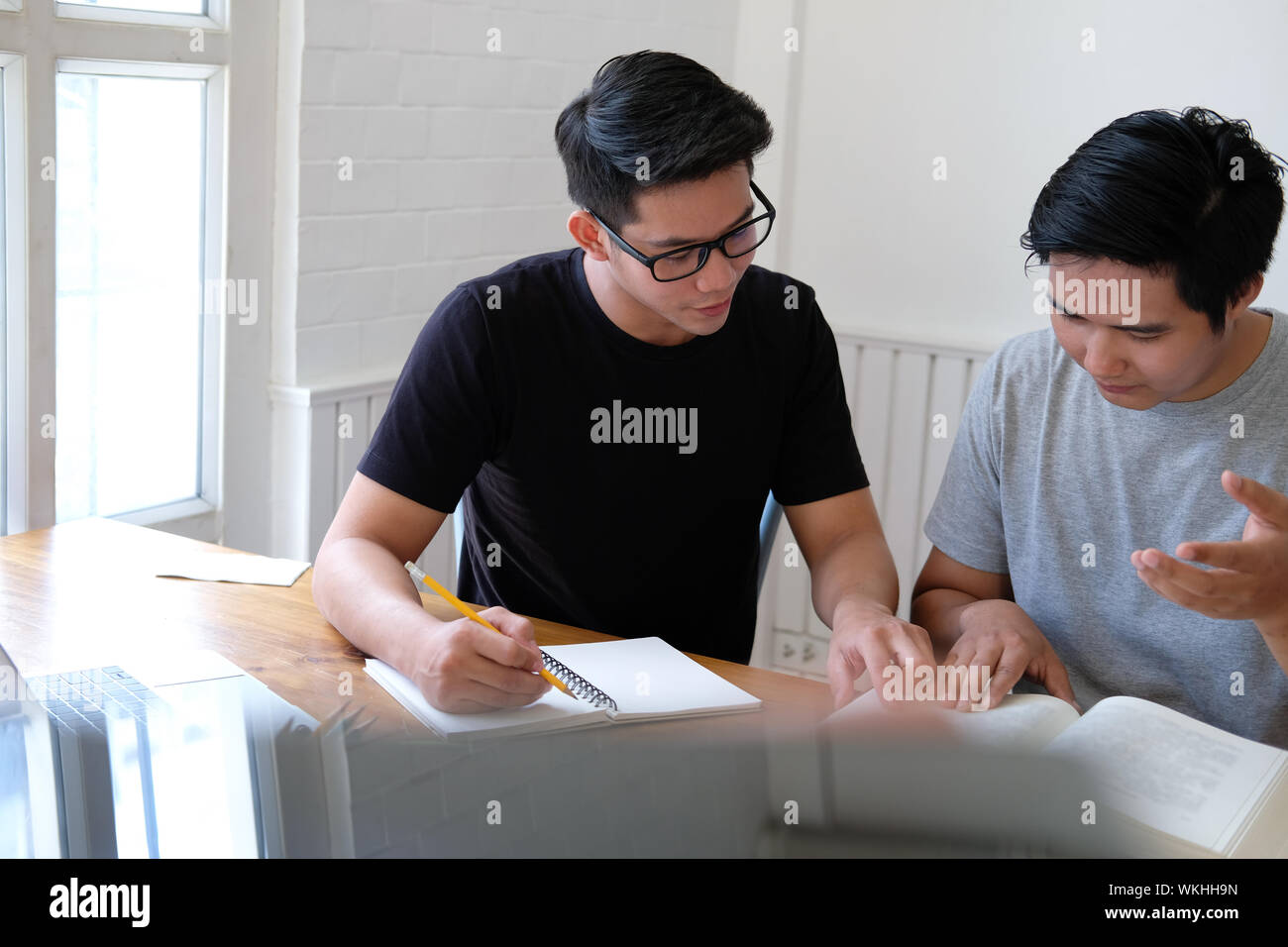 man college student studying learning talking discussing assignment ...