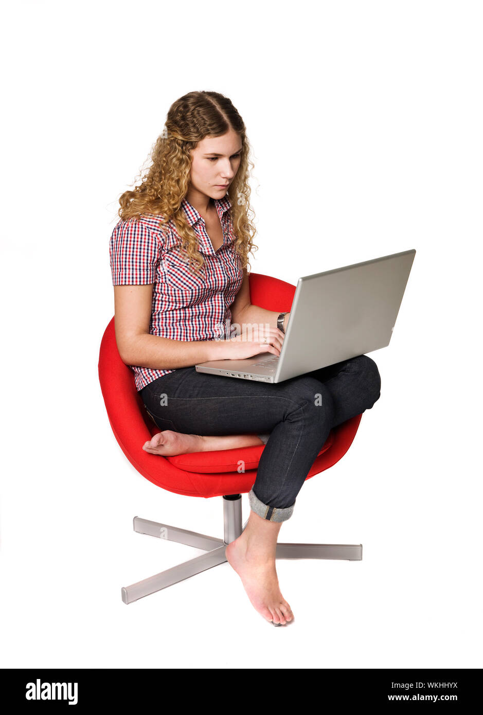 Girl in a armchair with a computer Stock Photo - Alamy