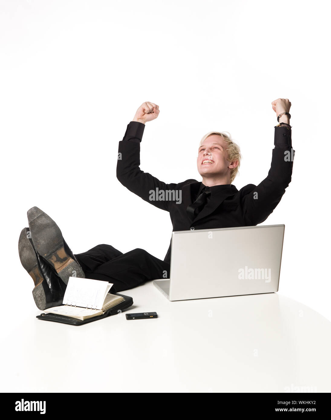 Happy boy siting infront of a computer Stock Photo - Alamy