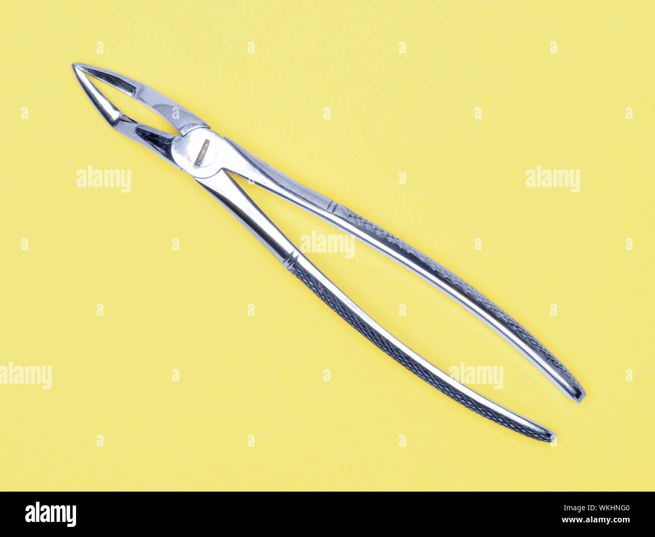 Dental surgical instrument on yellow background with copy space. Dental ...