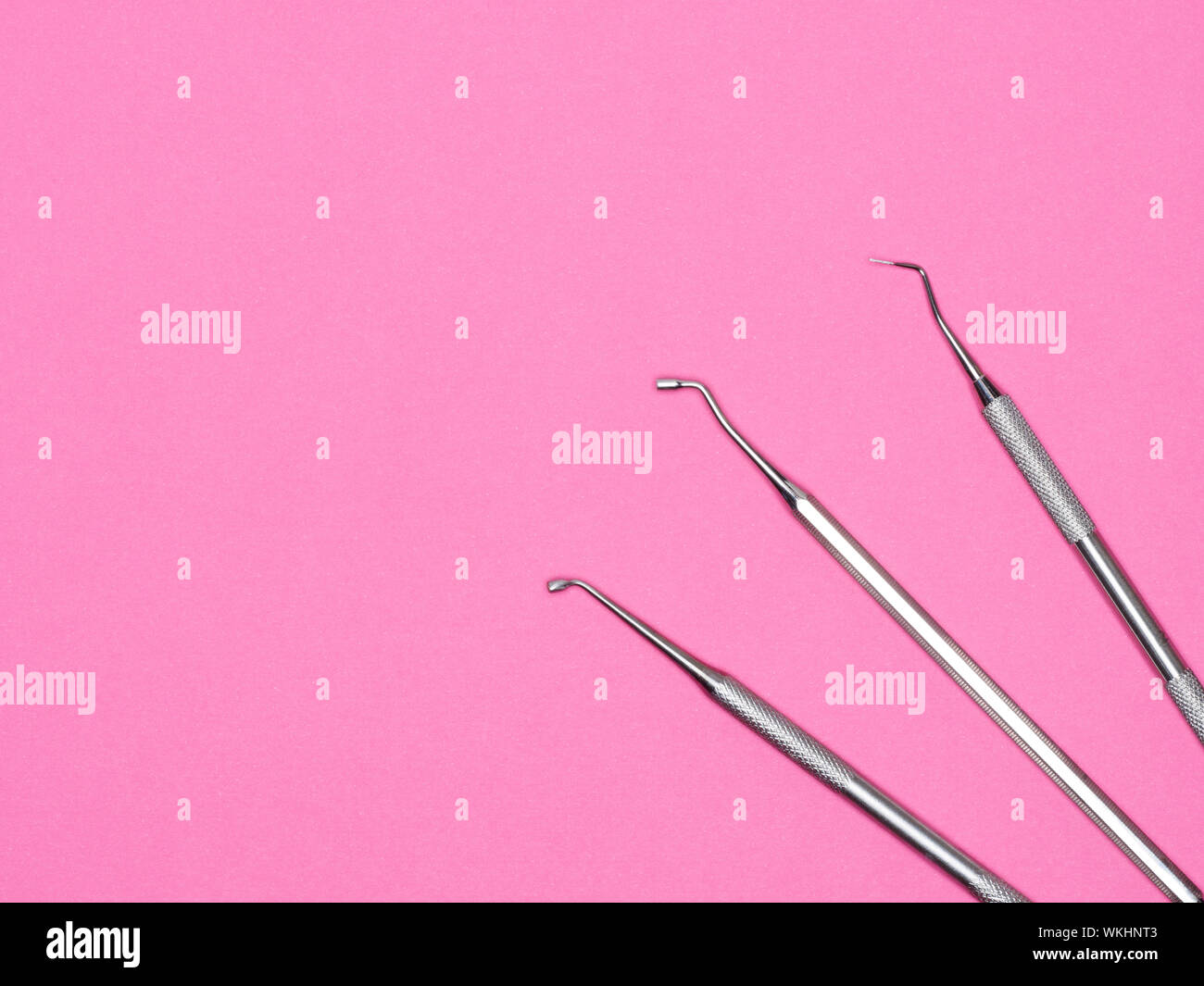 Dental instrument on pink background with copy space. Dental care ...