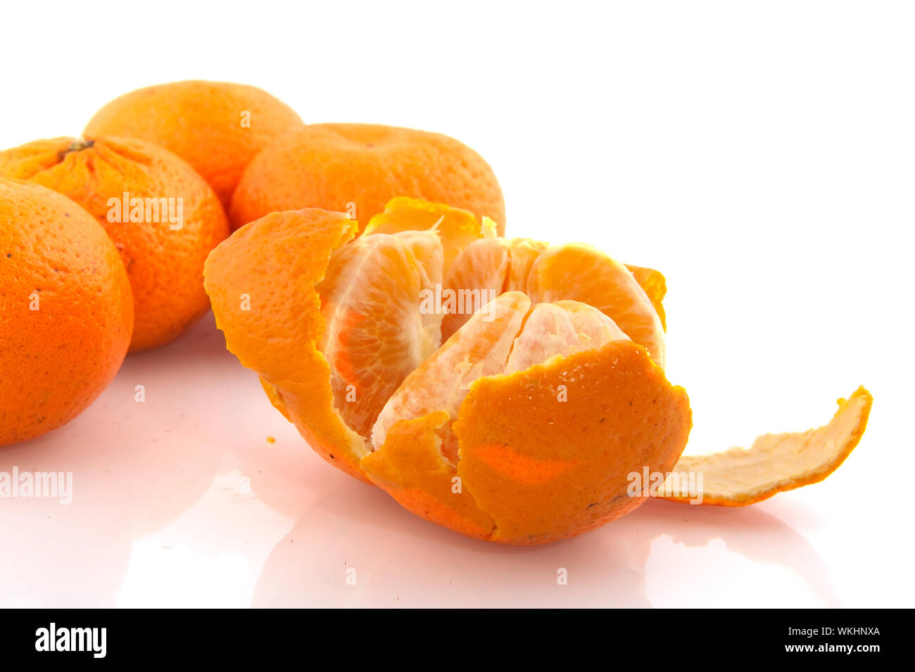 open peeled citrus tangerine isolated over white Stock Photo - Alamy