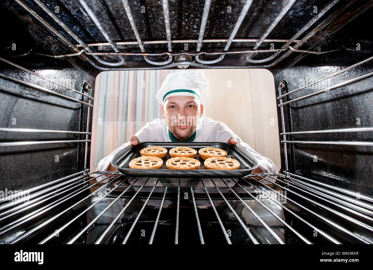 Chef prepares pastries in the oven, view from the inside of the oven ...