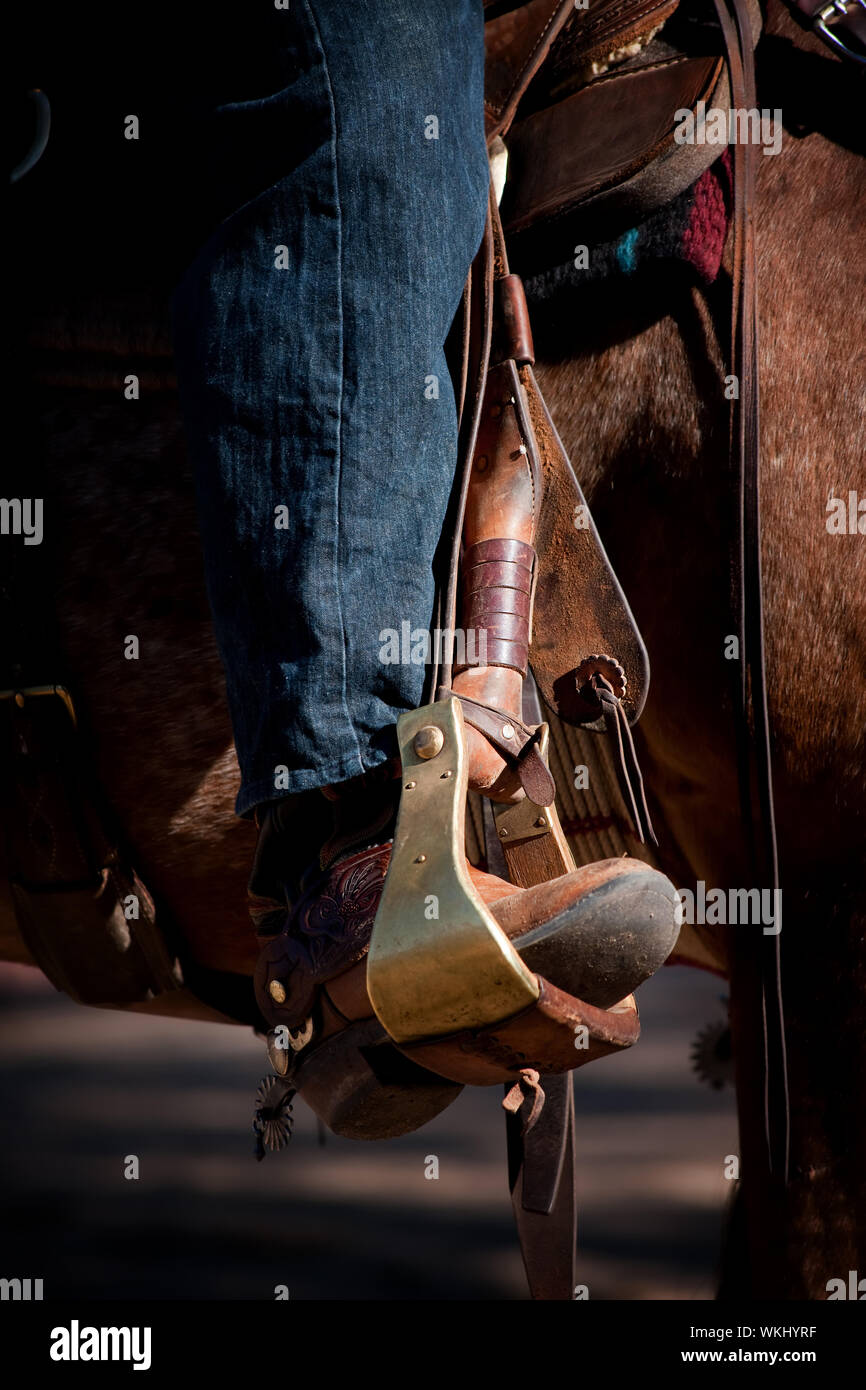 Cowboy leg and foot in stirrup on horse Stock Photo - Alamy