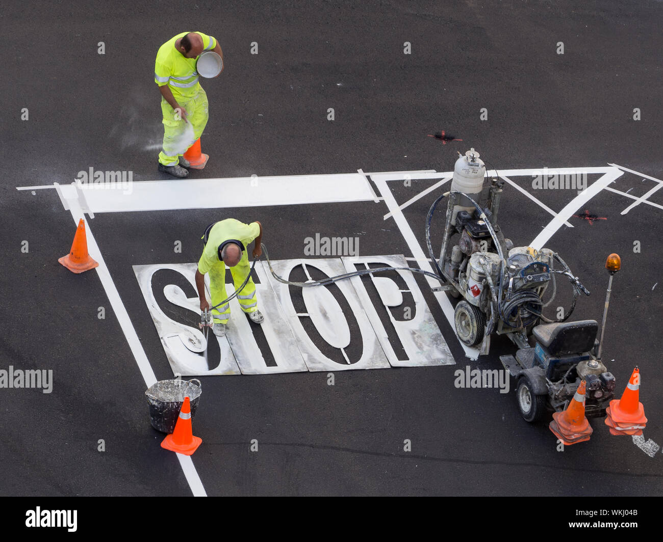 workers painting road signs, industry and teamwork Stock Photo - Alamy