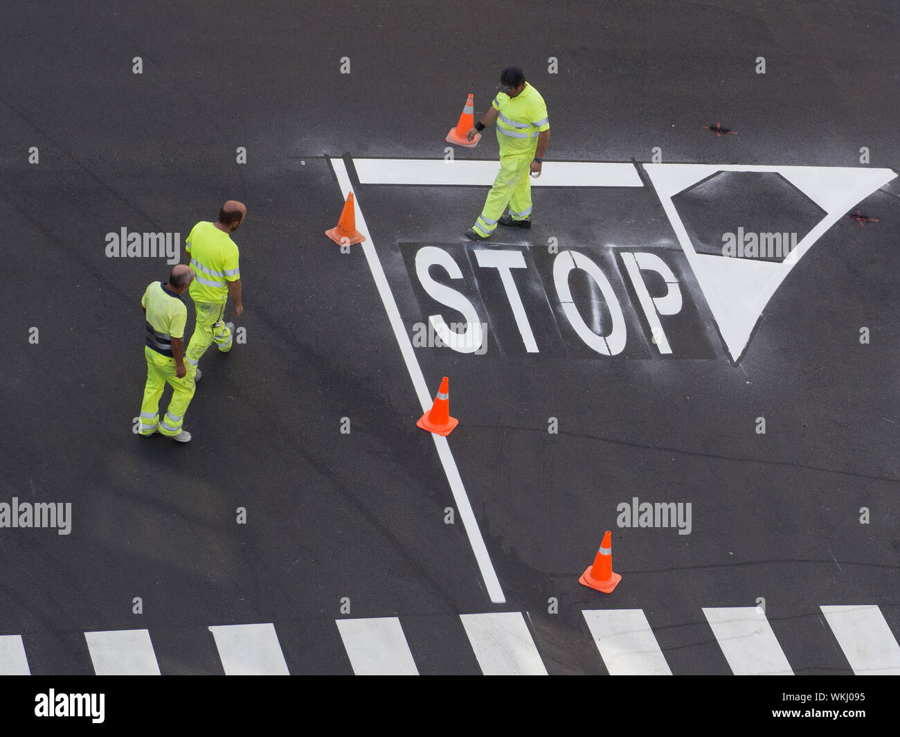 workers painting road signs, industry and teamwork Stock Photo - Alamy