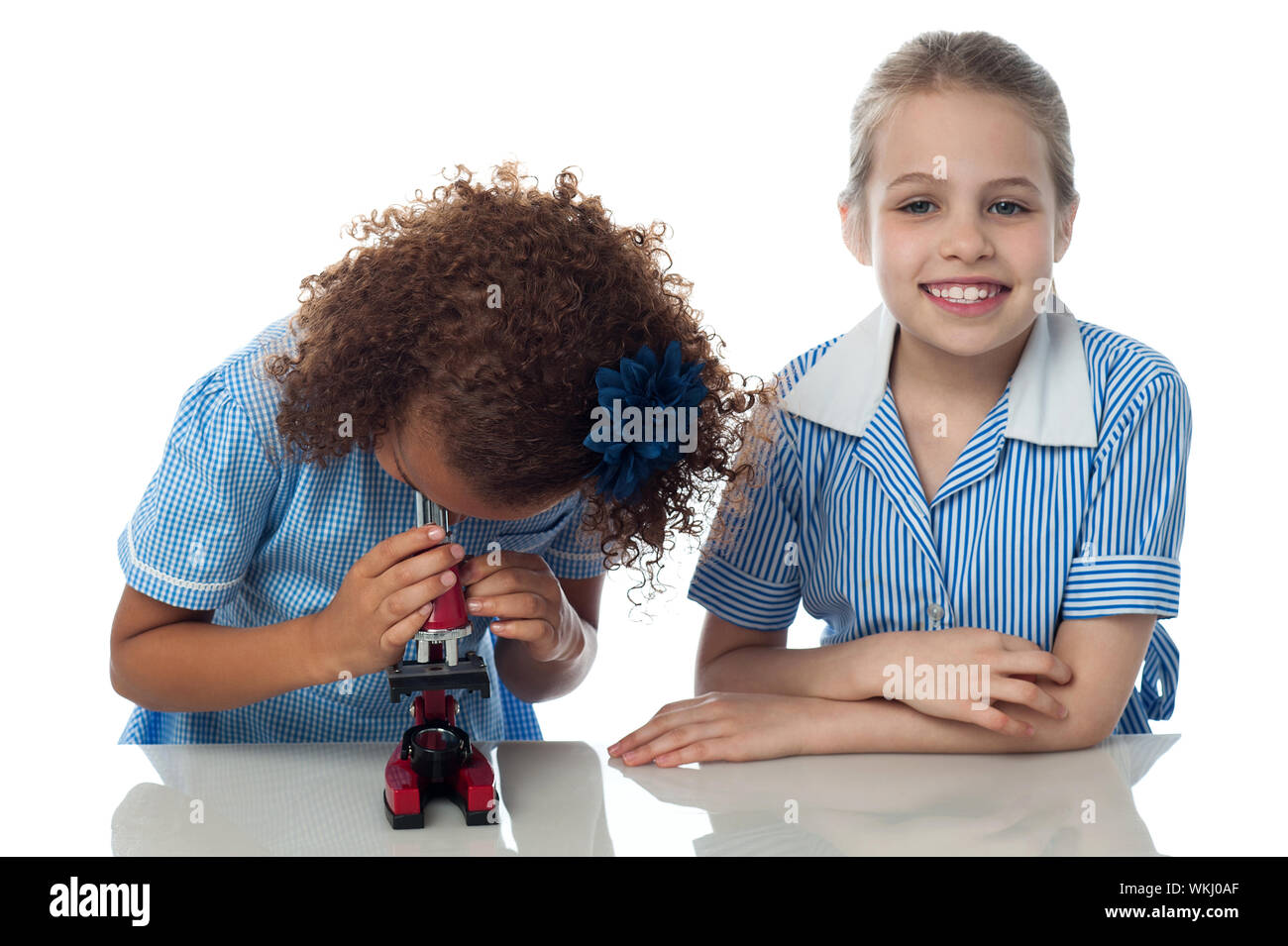 Kids in uniform using microscope in lab Stock Photo - Alamy