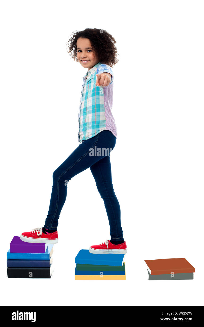Kid standing on pile books hi-res stock photography and images - Alamy