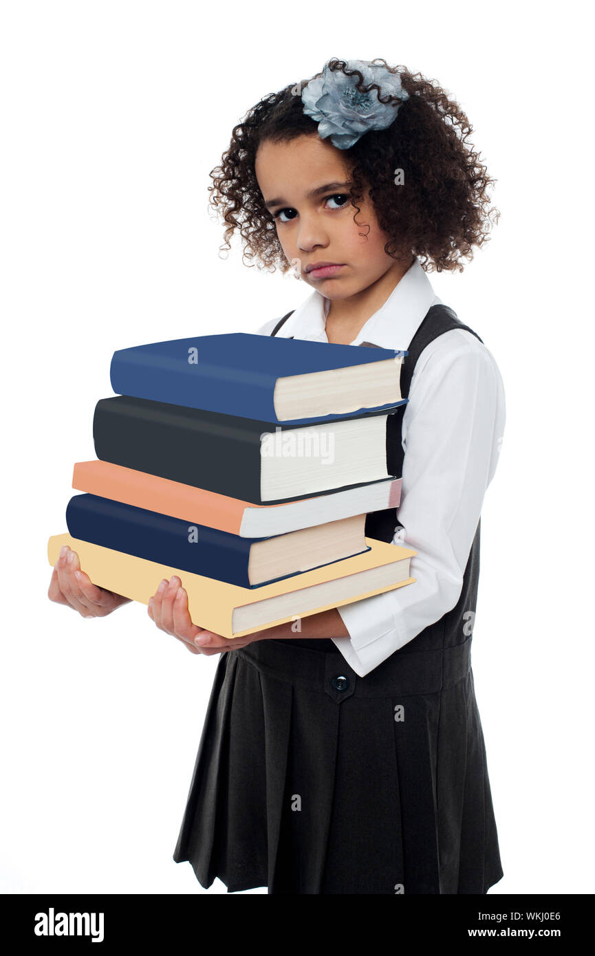 Sad faced girl holding stack of school books Stock Photo - Alamy