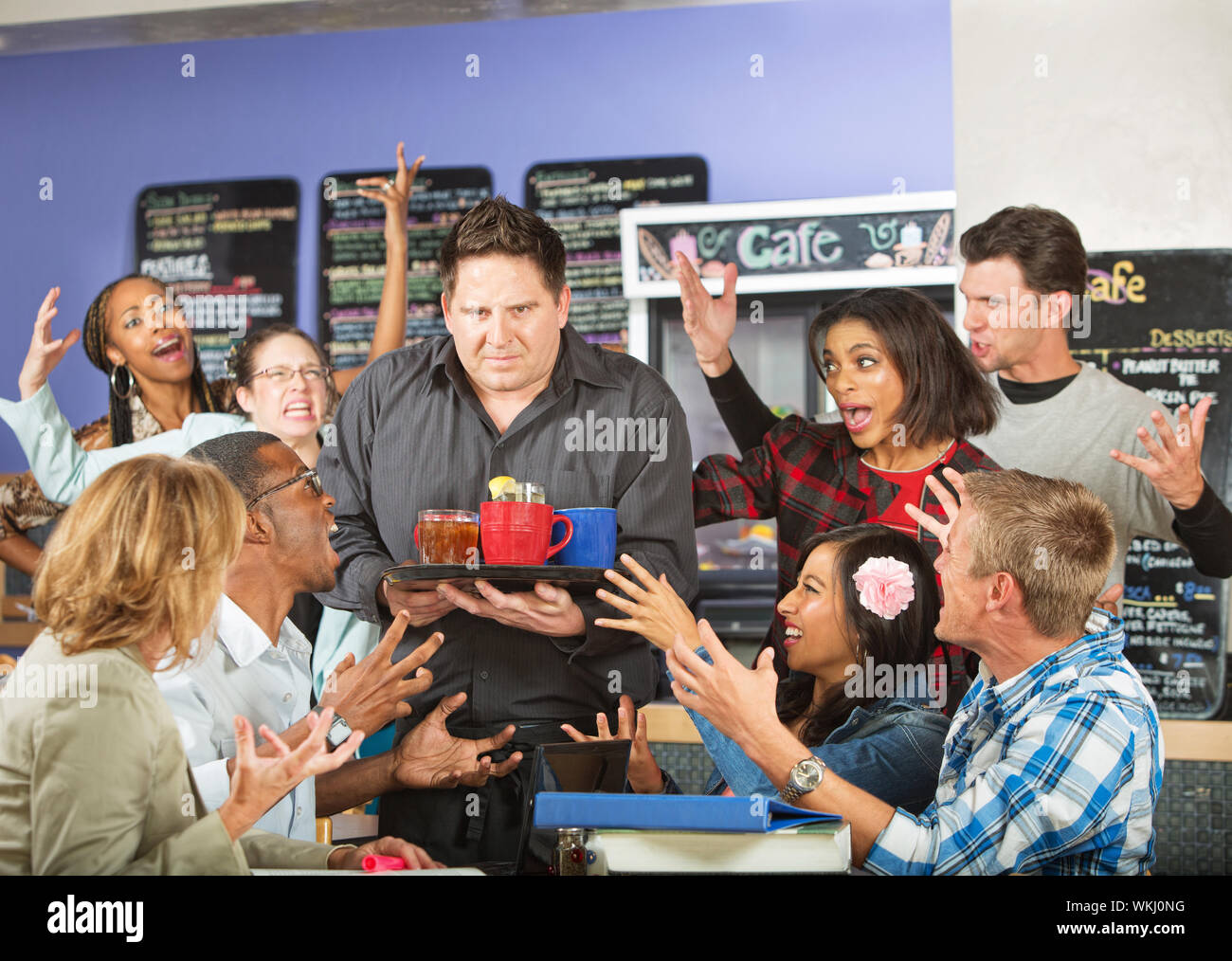 Diverse customers yelling at frustrated waiter in cafe Stock Photo - Alamy