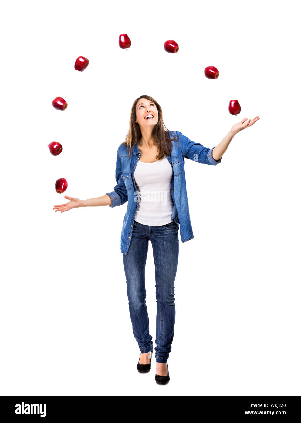 Healthy woman throwing apples, isolated over a white background Stock ...