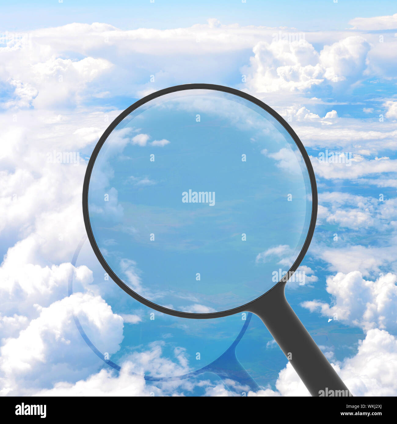 Magnifying glass looking sky in background. View from above the clouds ...