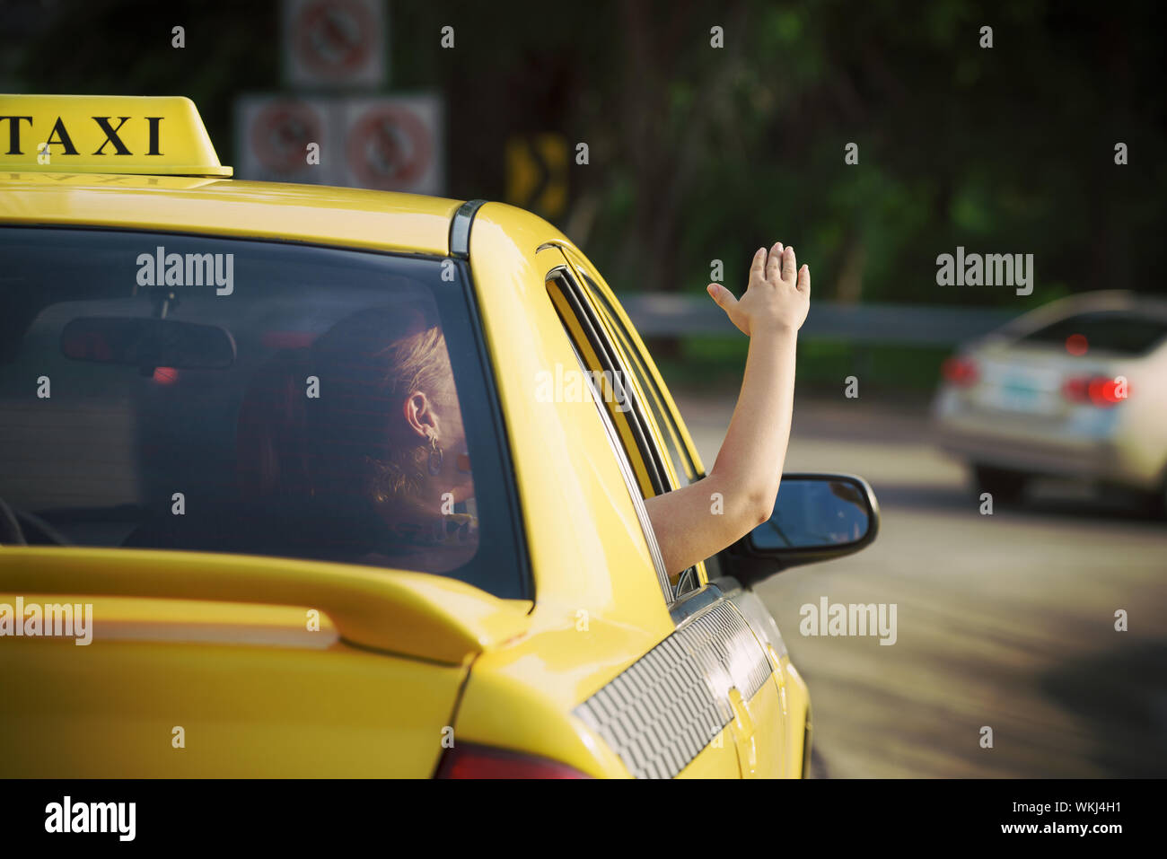 people travelling. Female passenger in taxi with arm outside of car ...