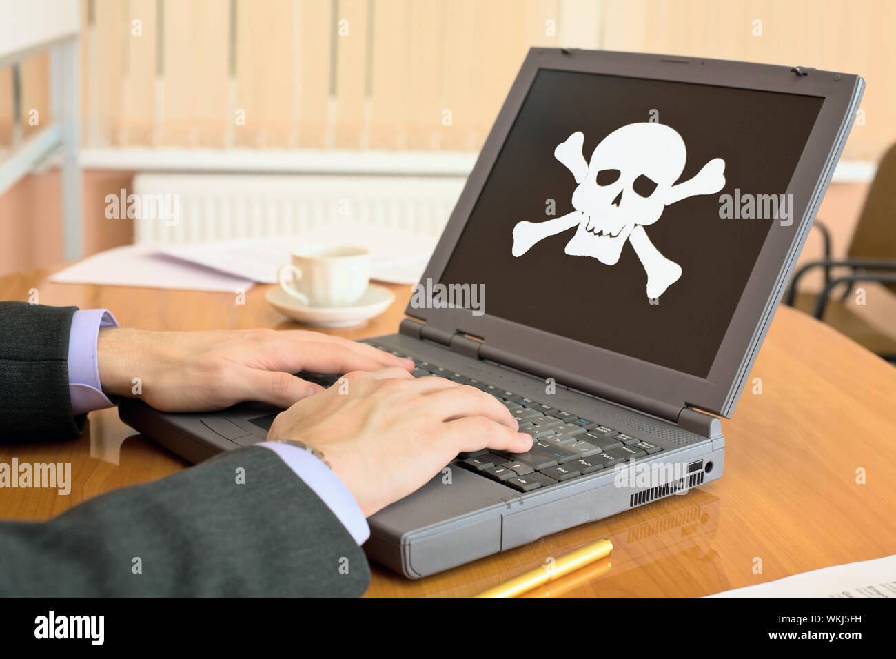 The gray laptop with the pirate software Stock Photo - Alamy