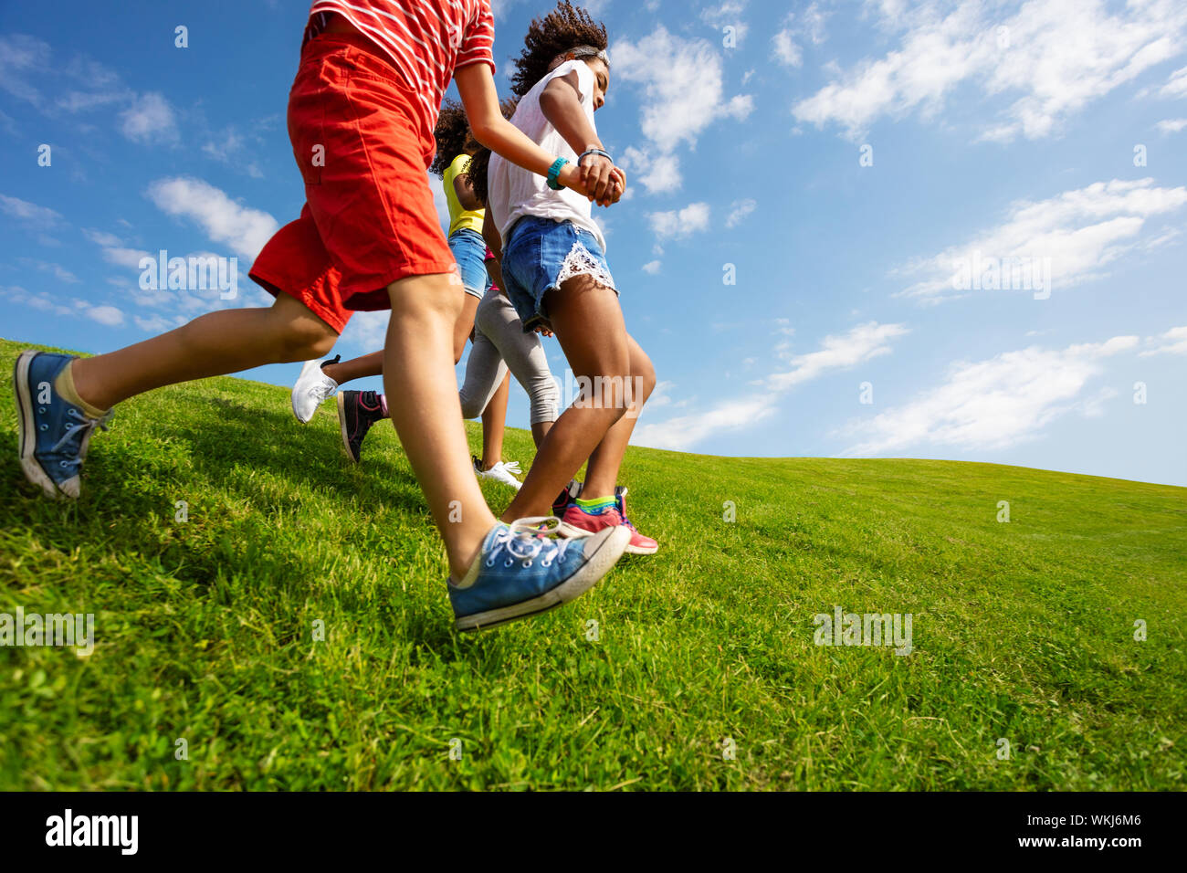 Close up of kids legs run down on the grass field Stock Photo - Alamy