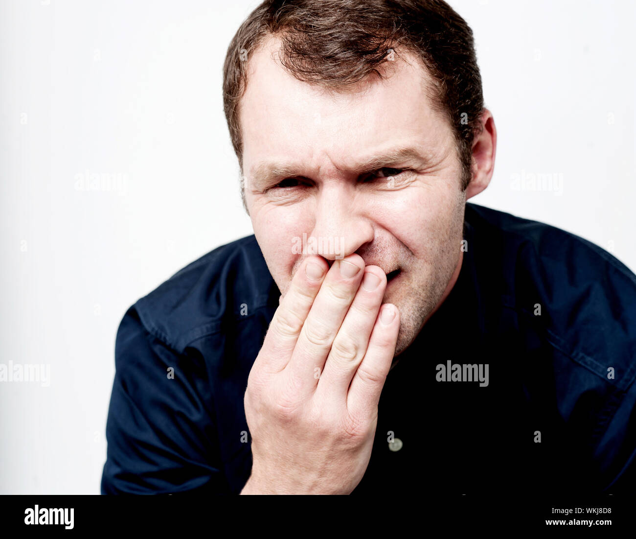 Man with hand over his mouth hi-res stock photography and images - Alamy