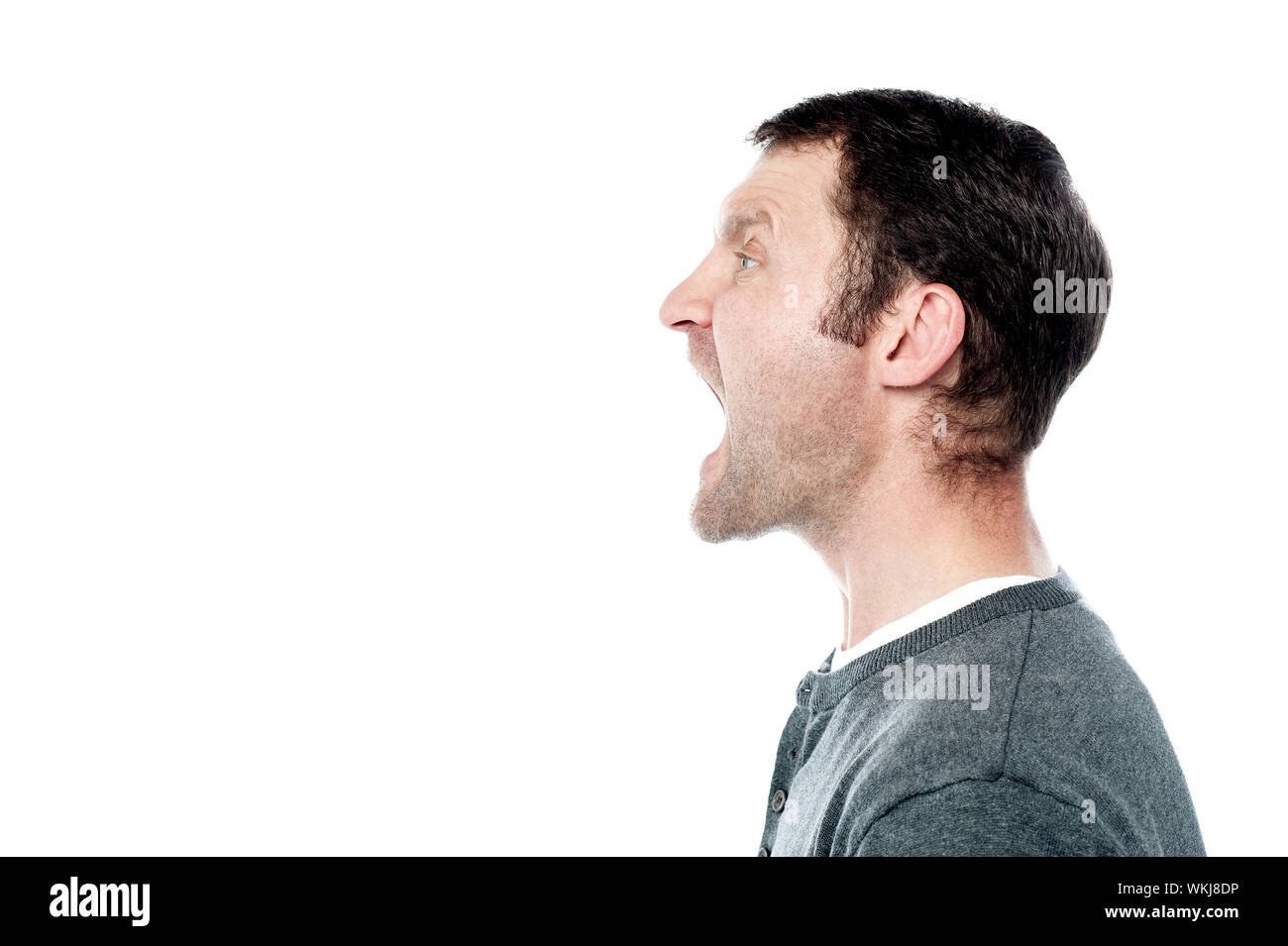 Side view of handsome male yelling Stock Photo - Alamy