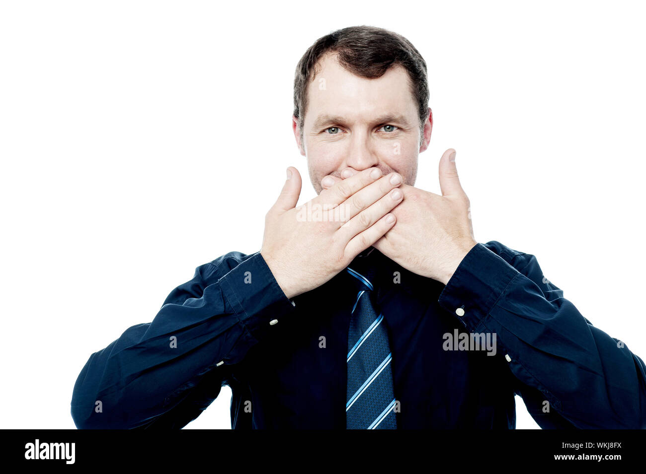 Smart corporate man making the speak no evil gesture Stock Photo - Alamy