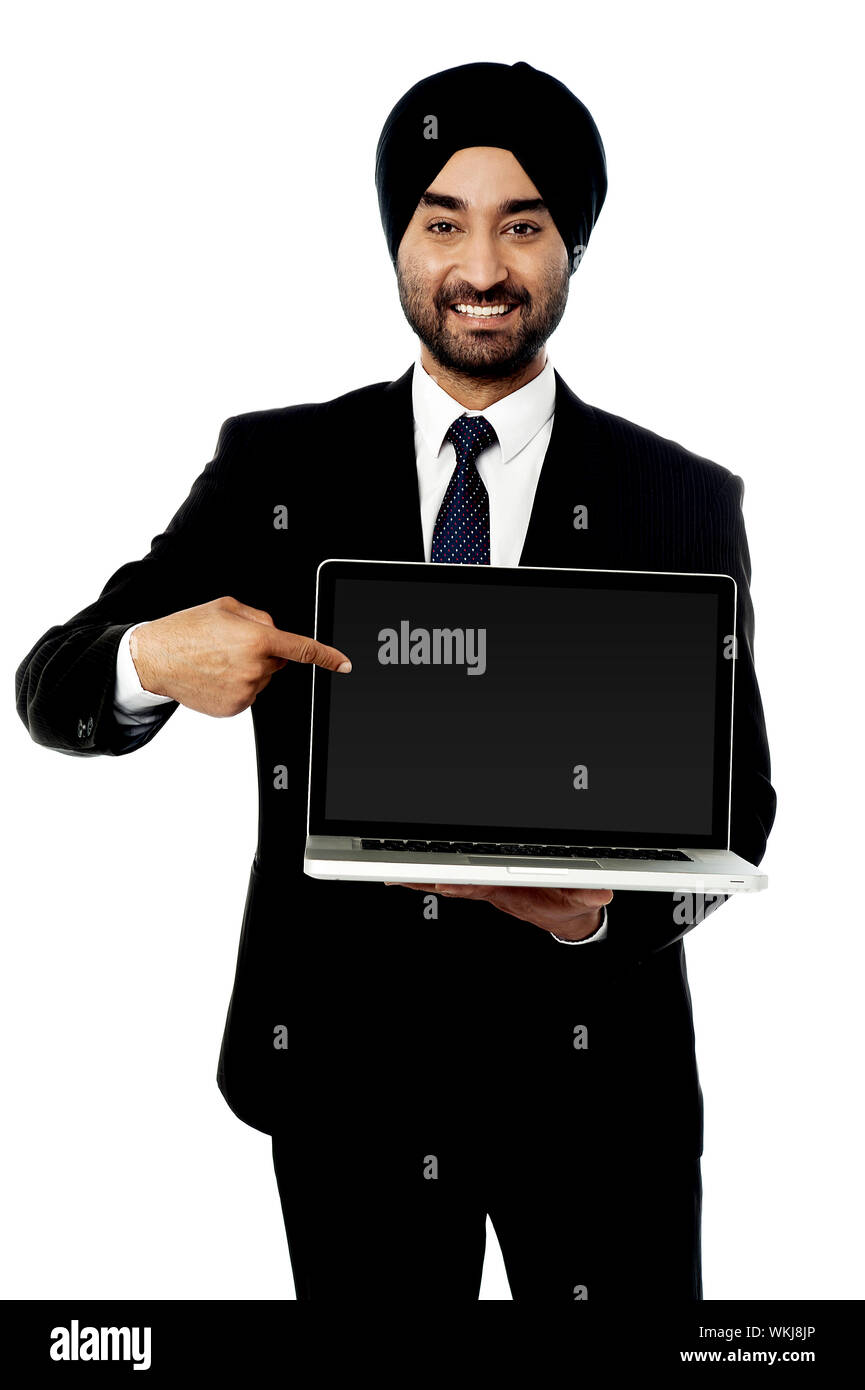 Indian salesman showing a laptop Stock Photo - Alamy