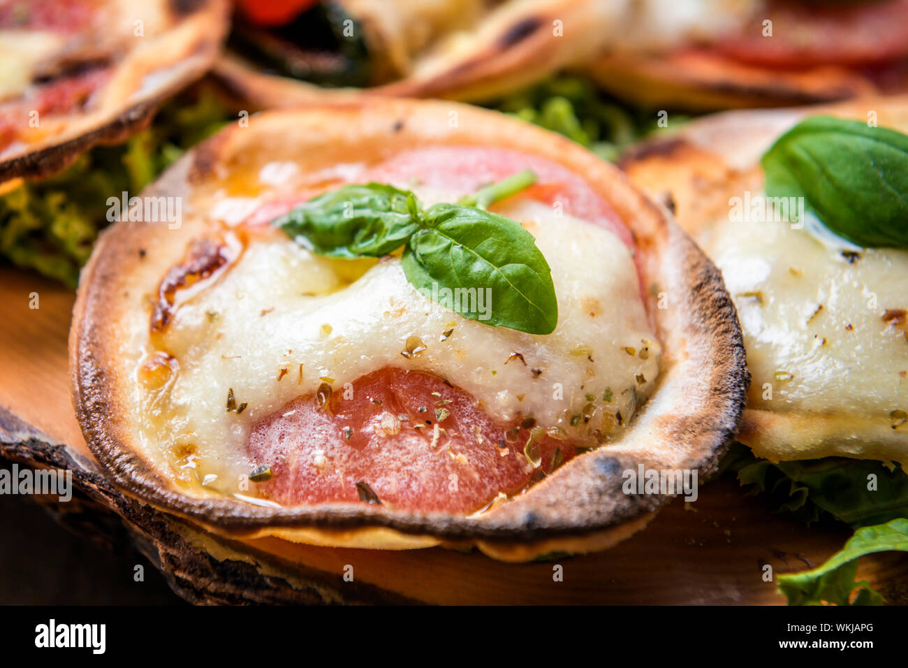 Image of italian mini pizza with basil, tomato, cheese and aubergine ...
