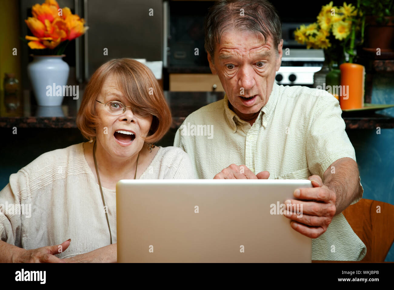 Senior couple shocked at the content on their laptop computer Stock ...