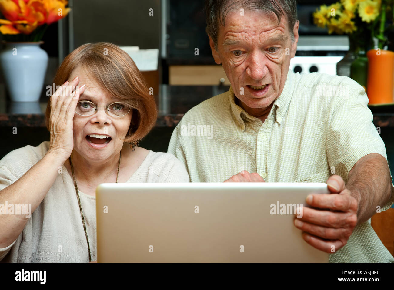 Senior couple shocked at the content on their laptop computer Stock ...