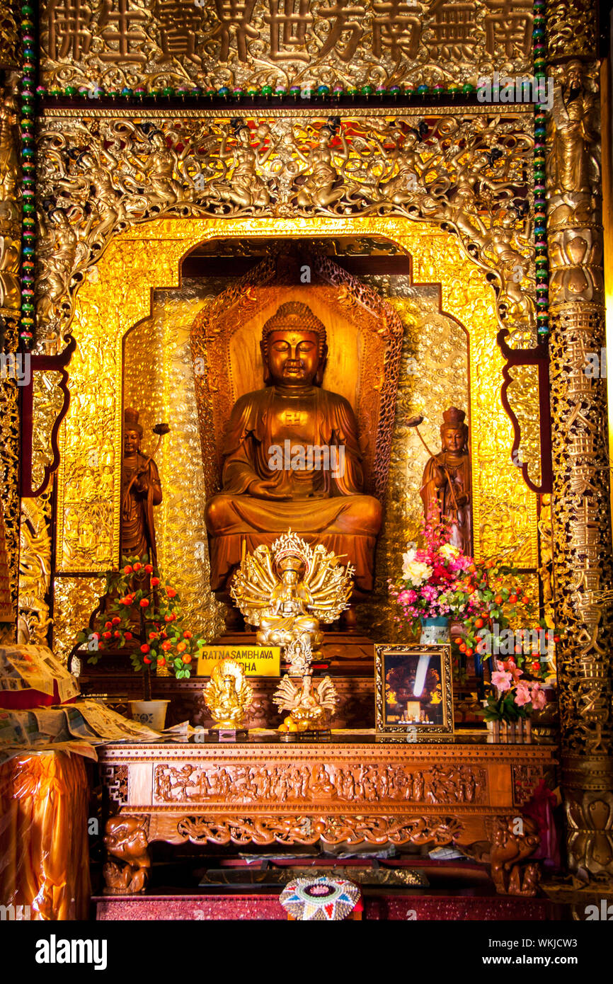 Interior of an ornate Asian temple with statues f deities in recesses ...