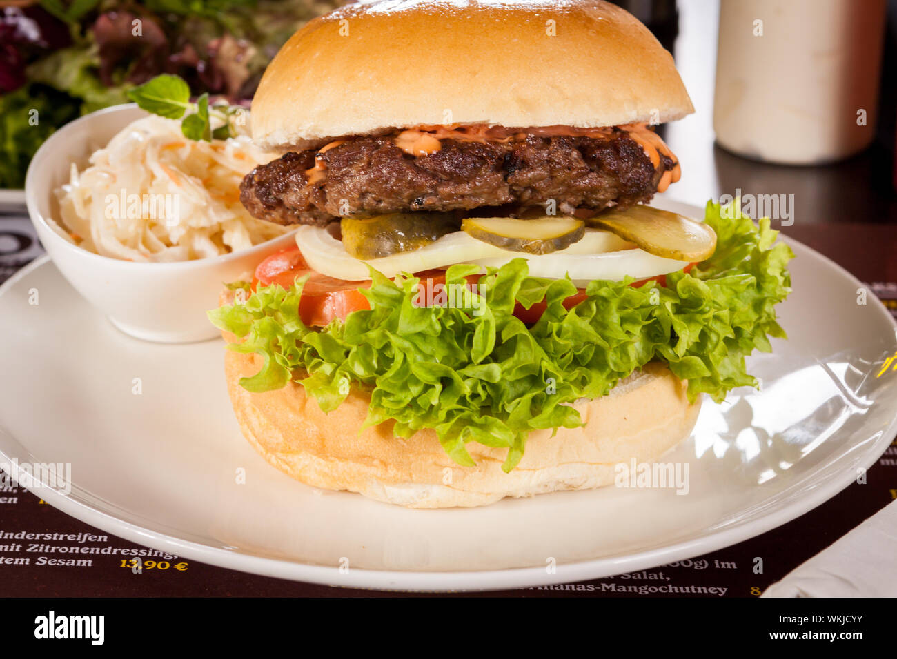 Tasty traditional cheeseburger with a ground beef patty topped with ...
