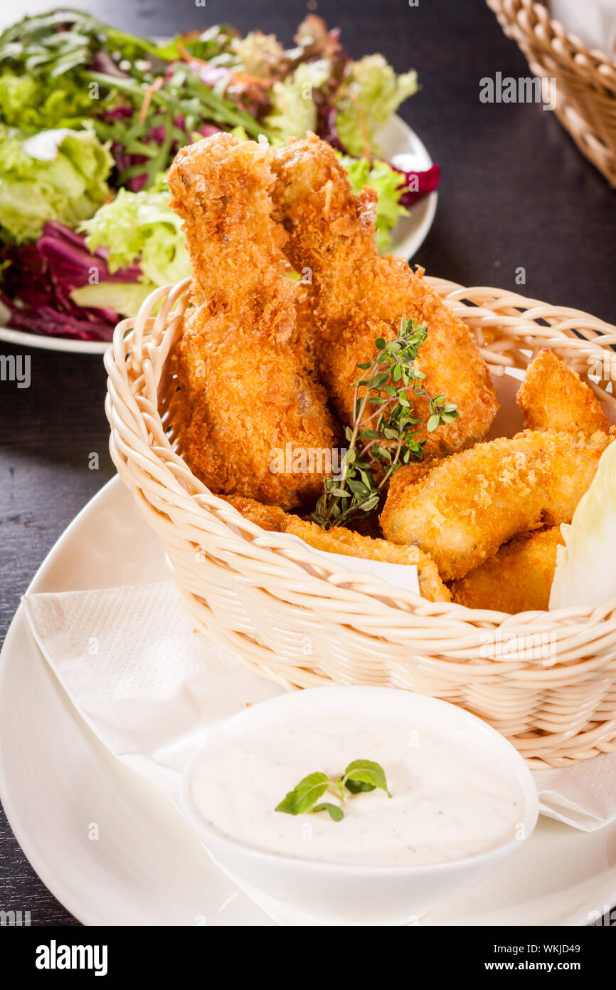 Crisp crunchy golden chicken legs and wings deep fried in bread crumbs ...