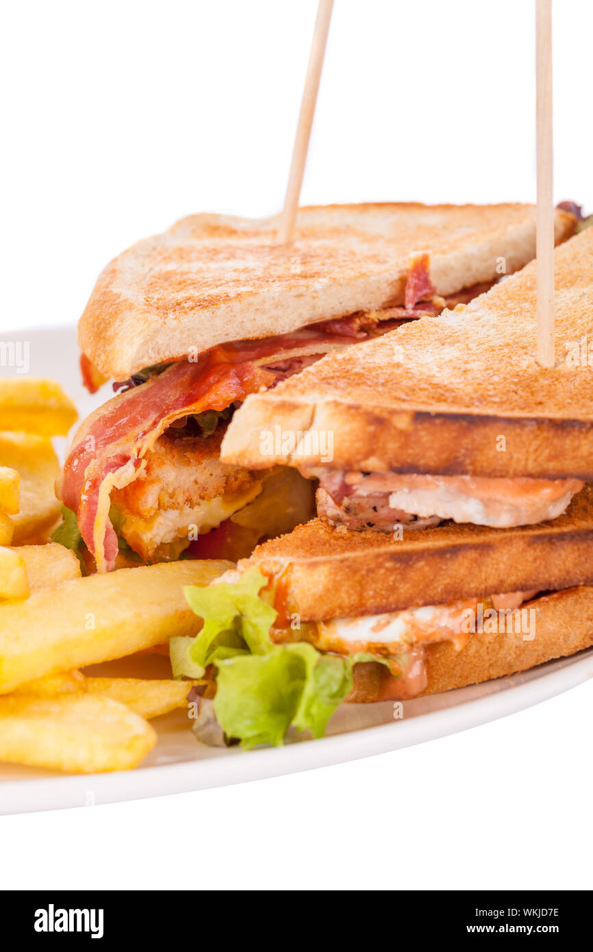 Club sandwich on toasted white bread with a meat filling served with ...