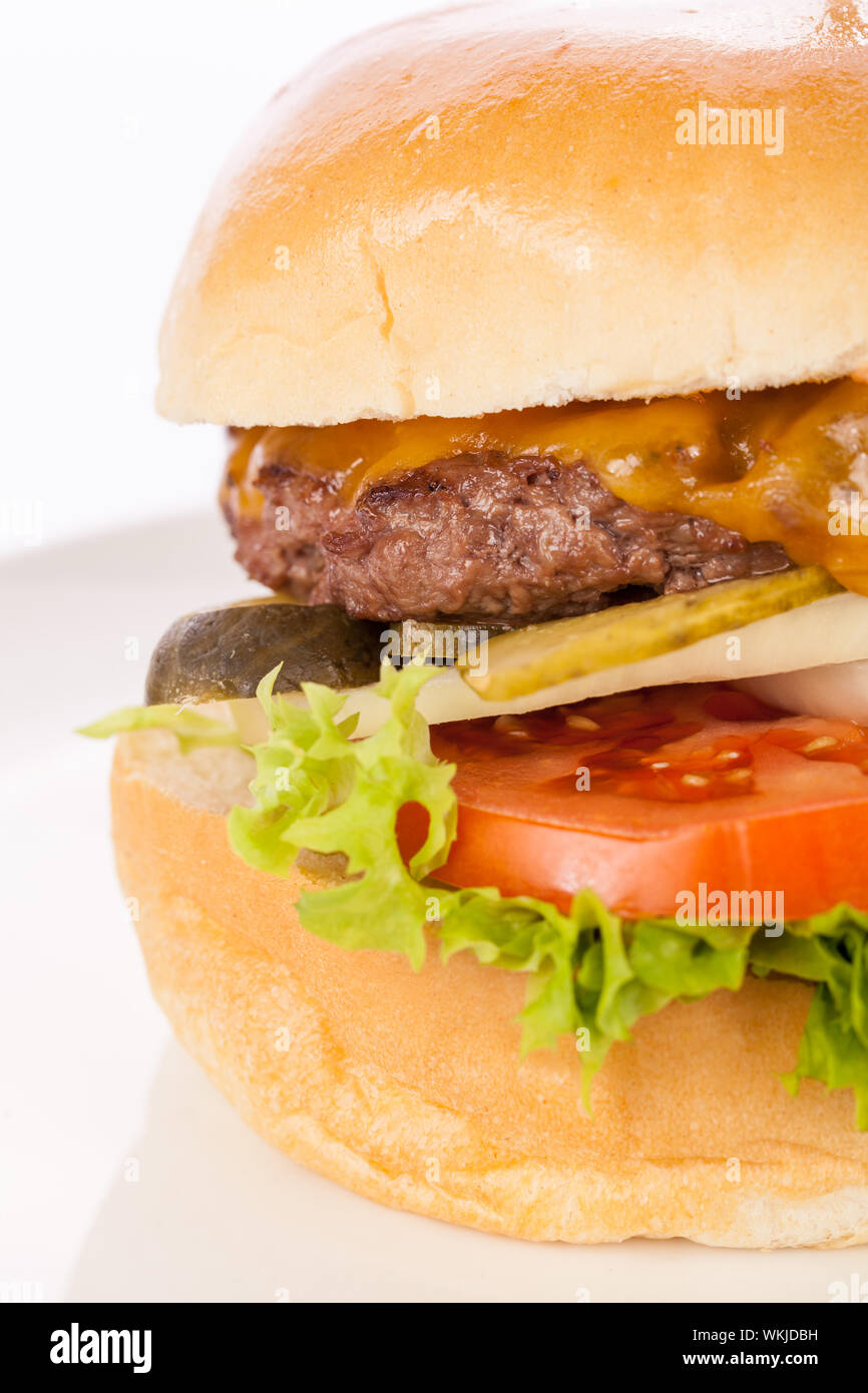 Tasty traditional cheeseburger with a ground beef patty topped with ...