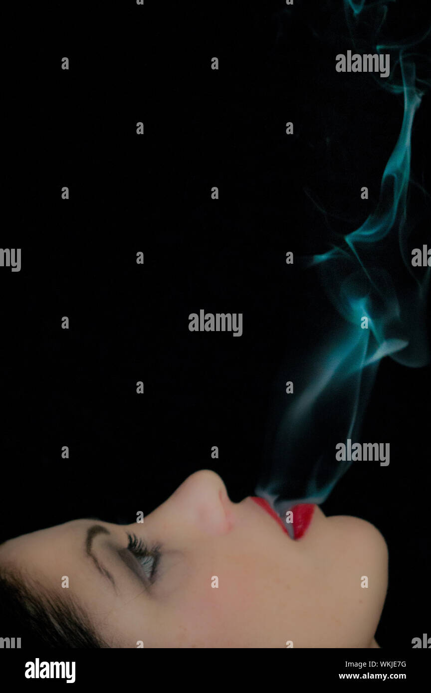Woman exhaling smoke hi-res stock photography and images - Alamy