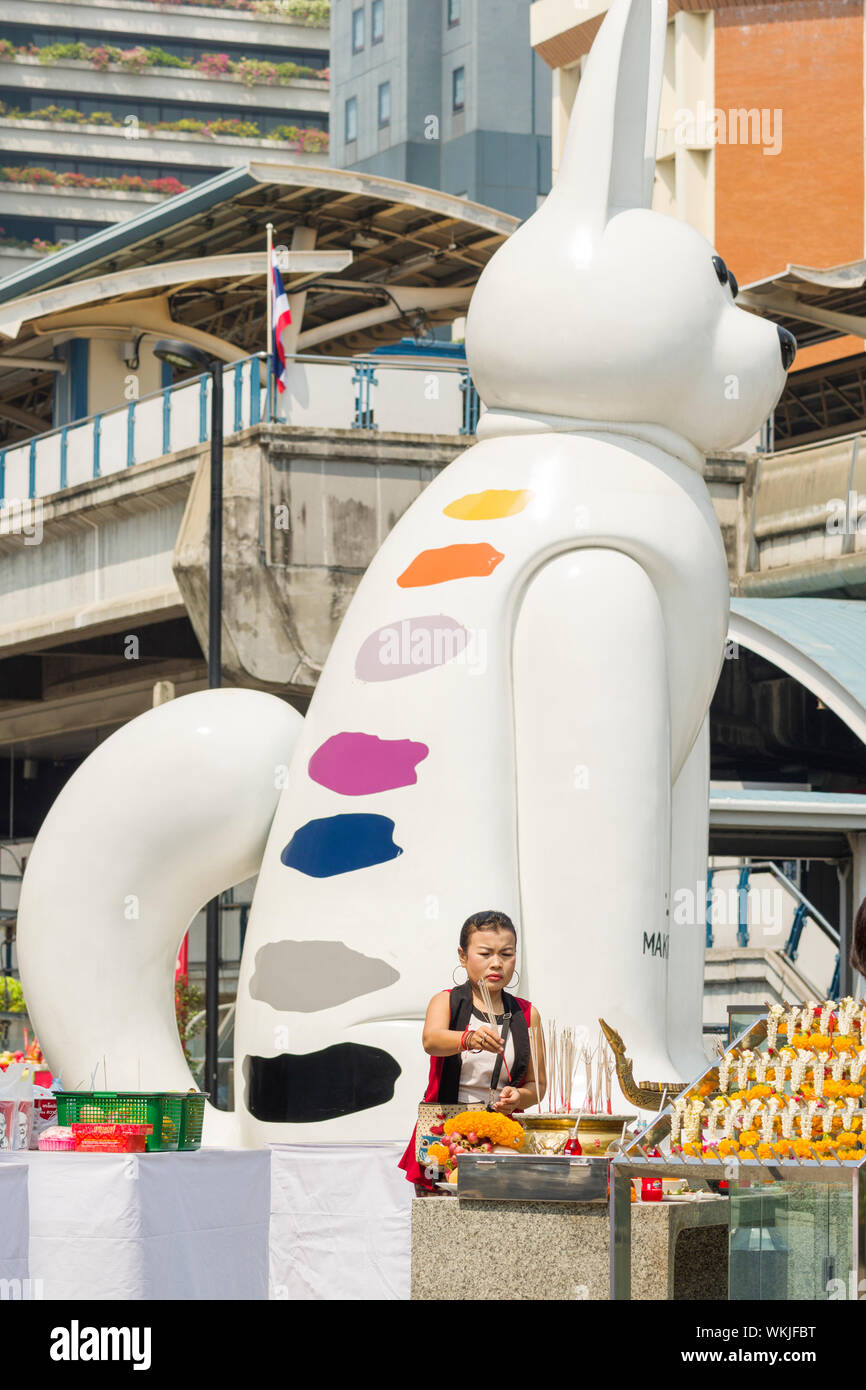 offerings in front of a house of spirits and Makrub, the mascot of the ...