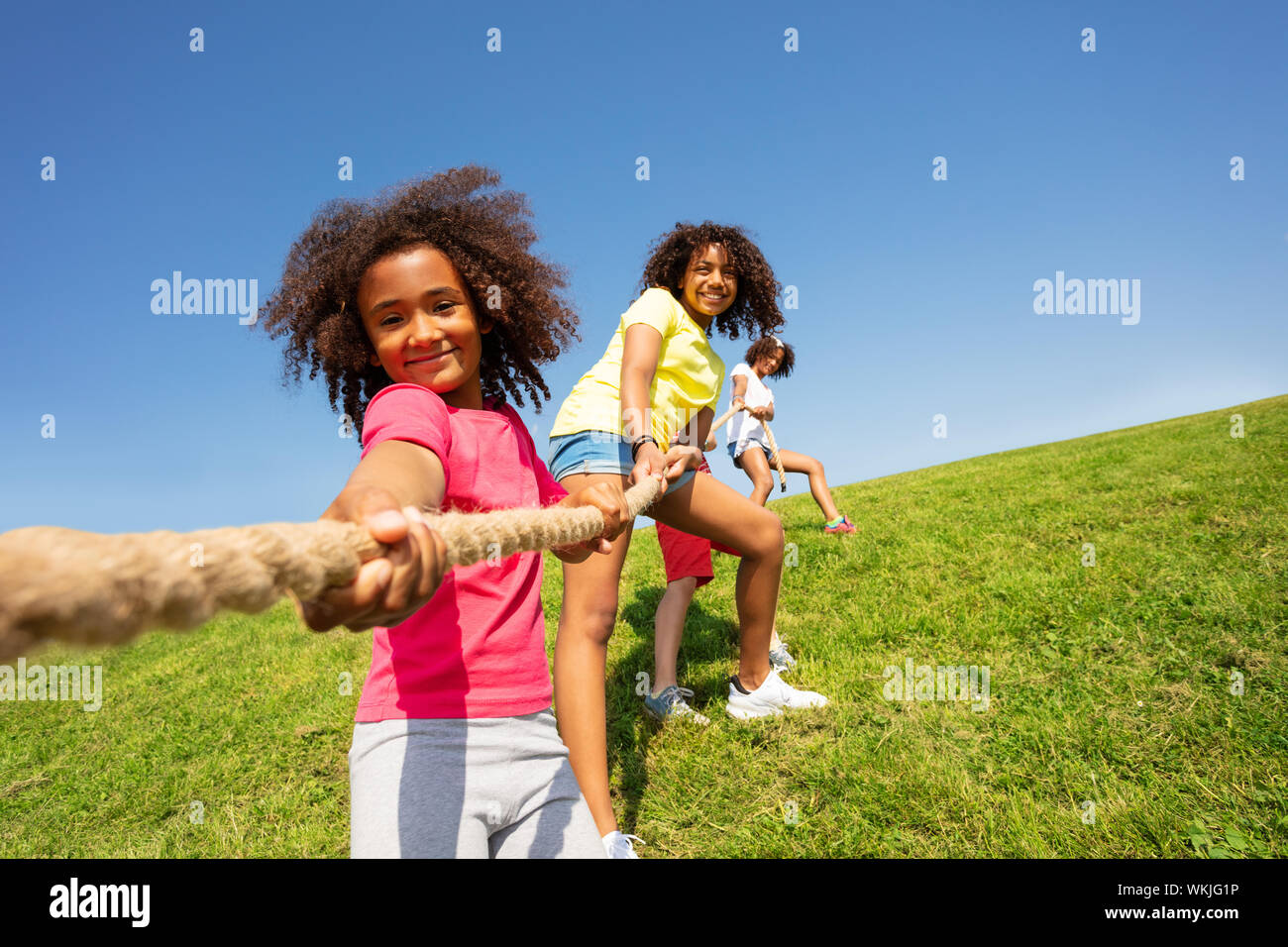 Kids pulling rope hi-res stock photography and images - Alamy