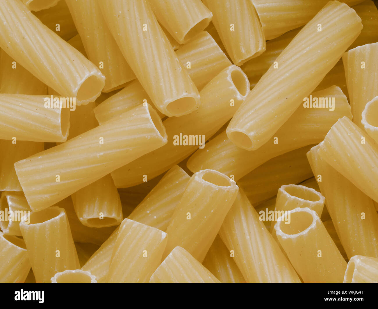 close up of raw uncooked maccheroni pasta tubes food texture background ...