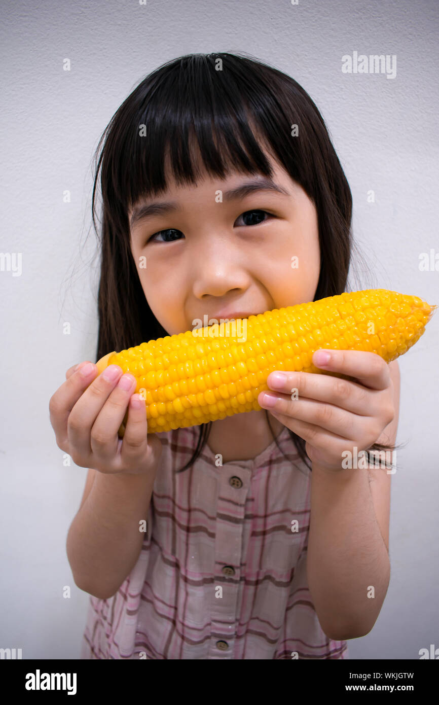 Indian girl eating corn hi-res stock photography and images - Alamy