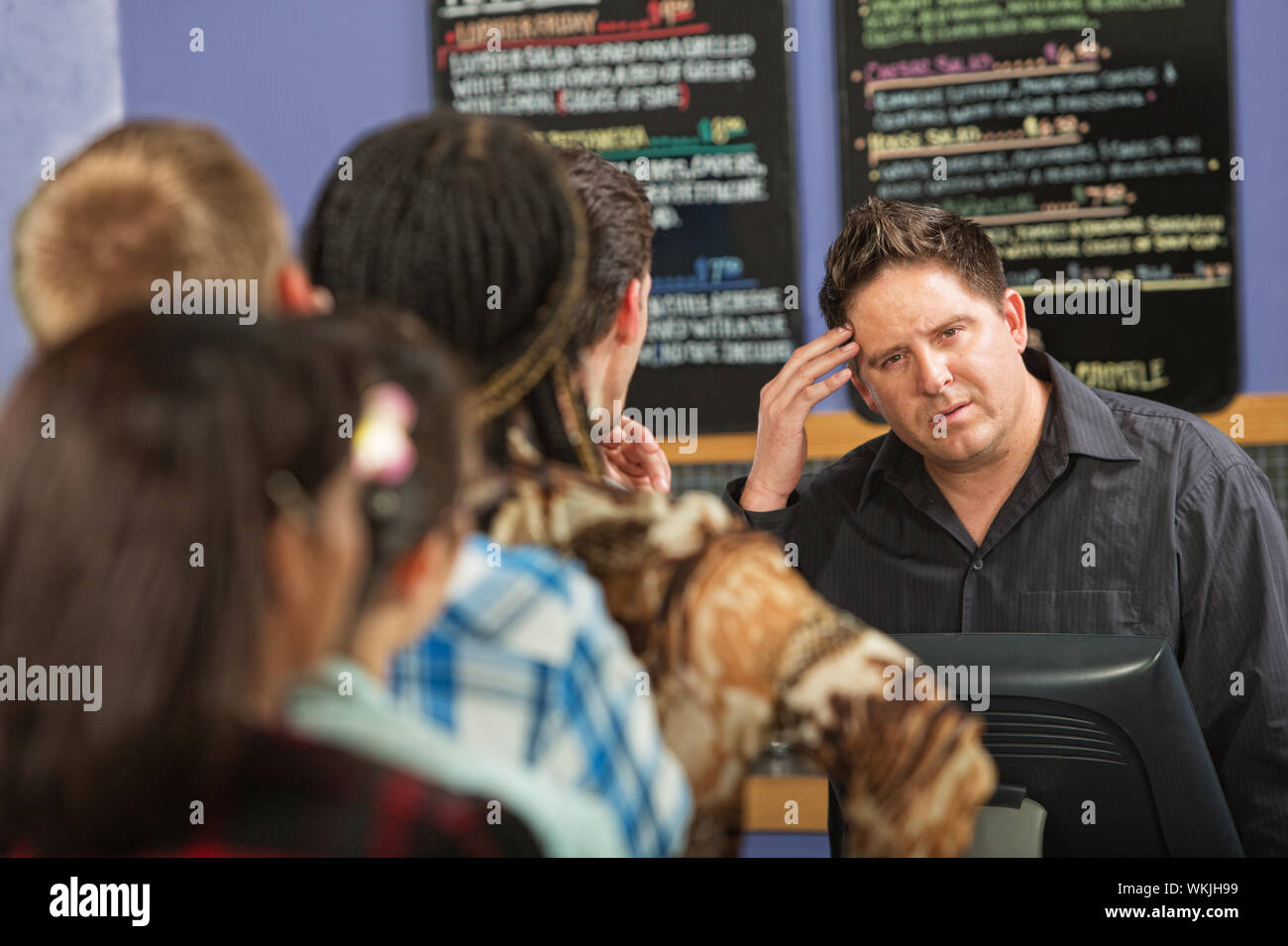 Confused barista at cash register in cafe Stock Photo - Alamy