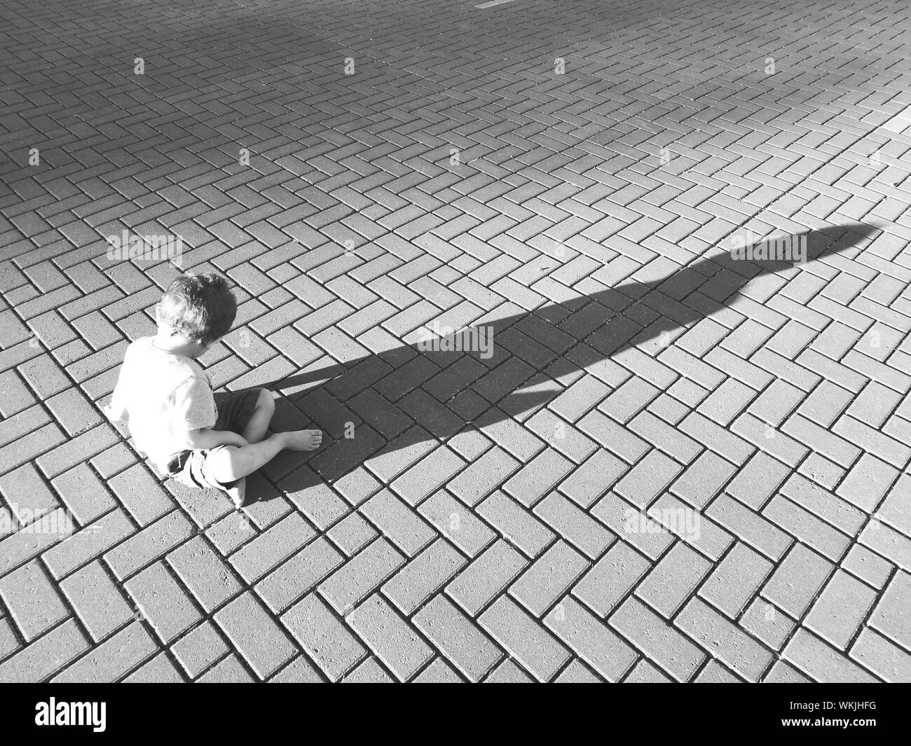Boy sitting on stone hi-res stock photography and images - Alamy