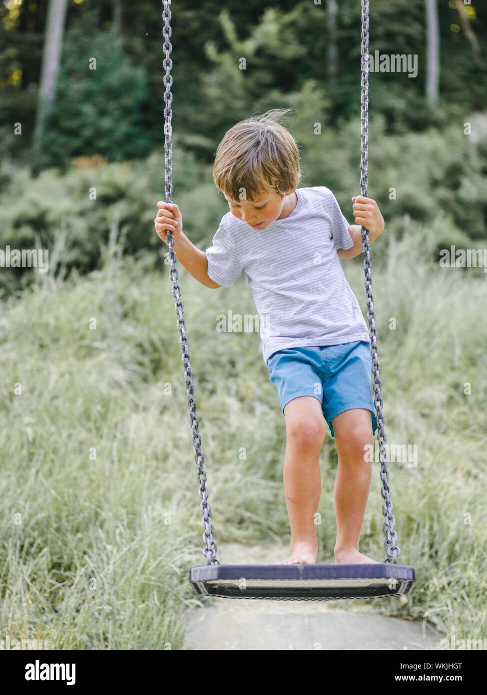 Boy standing swing hi-res stock photography and images - Alamy