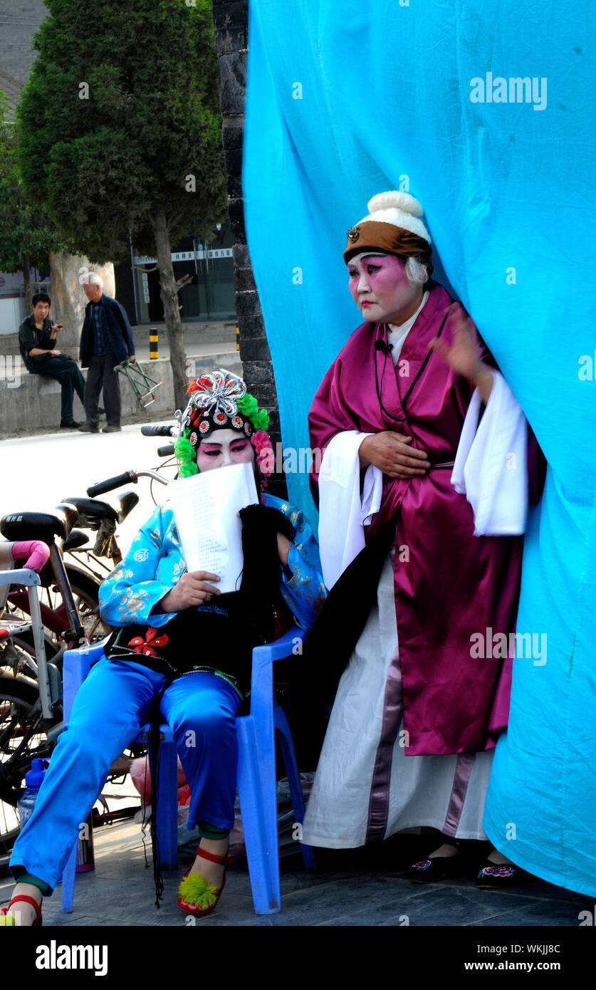 Artists prepare themeselves back stage during a roadside theatre ...