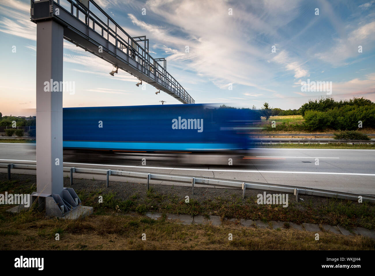 truck passing through a toll gate on a highway (motion blurred image ...
