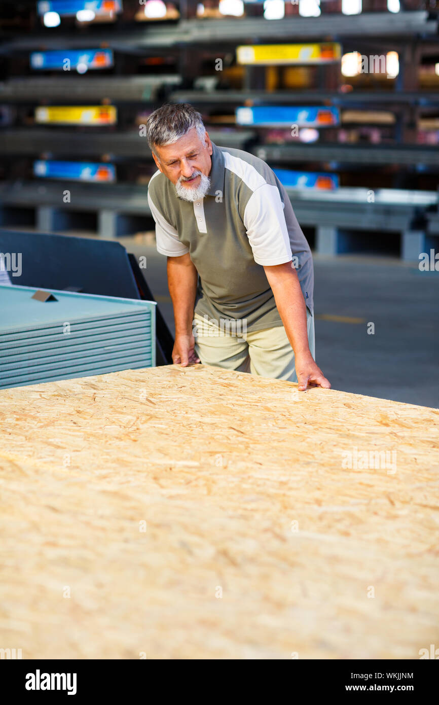 Man choosing and buying construction wood in a DIY store for his DIY ...