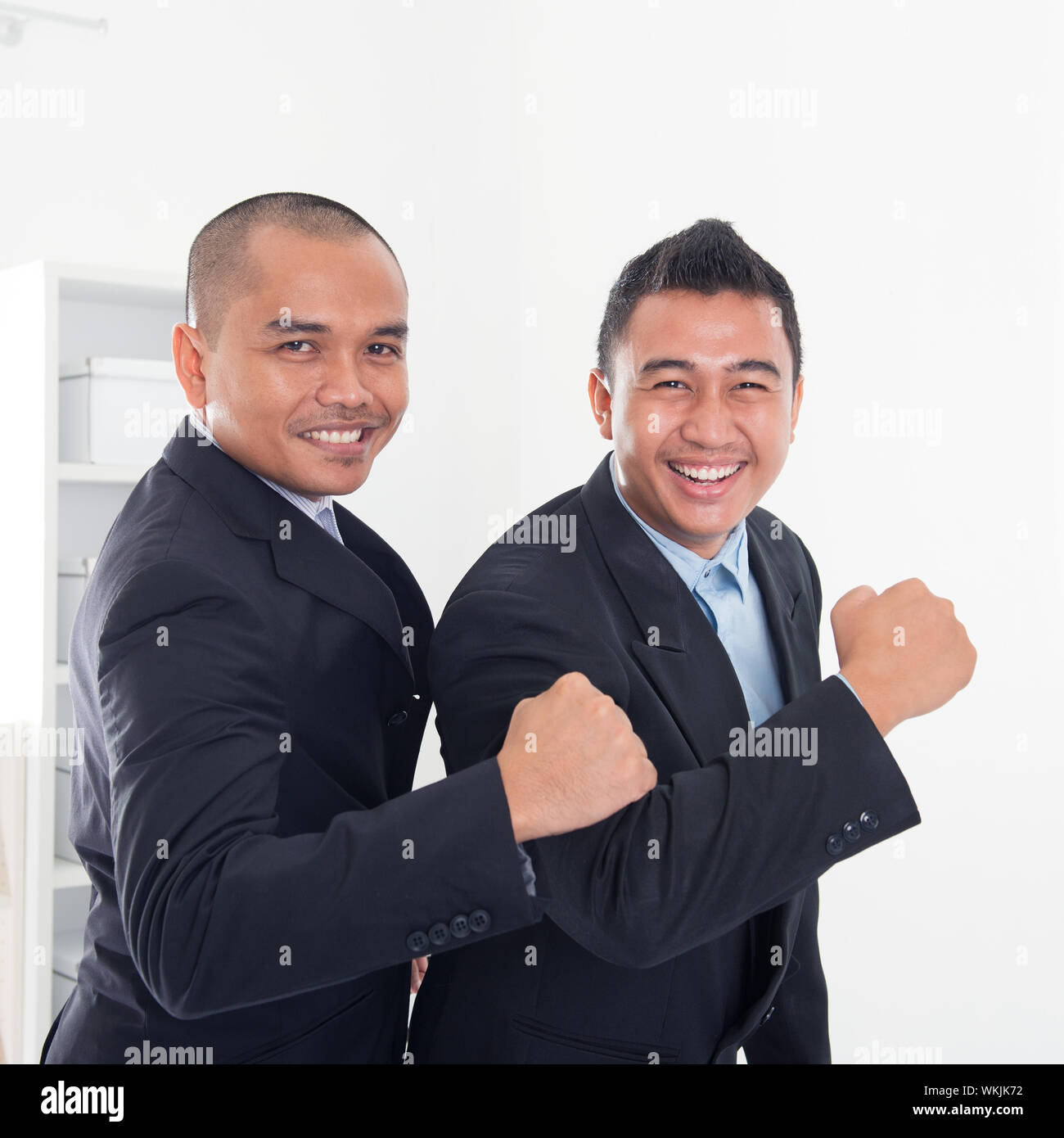 Southeast Asian business men celebrating success in office Stock Photo ...