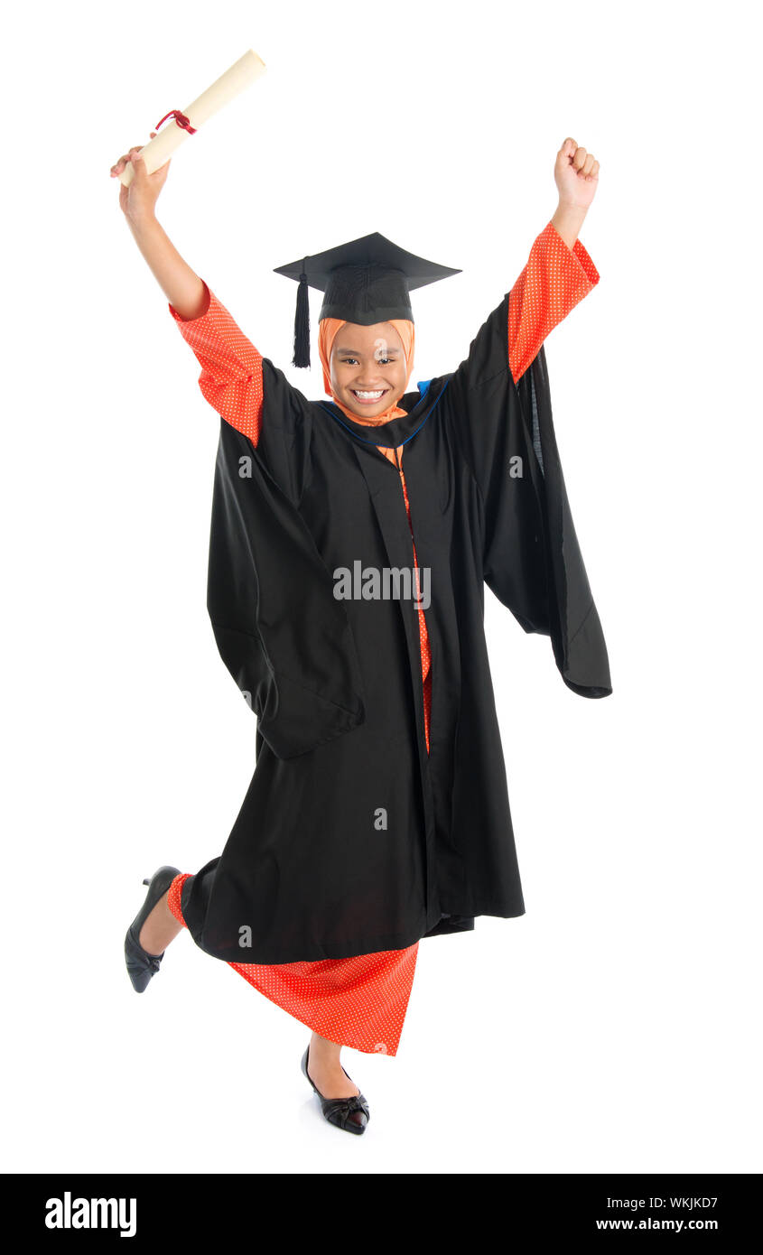 Portrait of full length smiling Asian female Muslim student in graduate ...