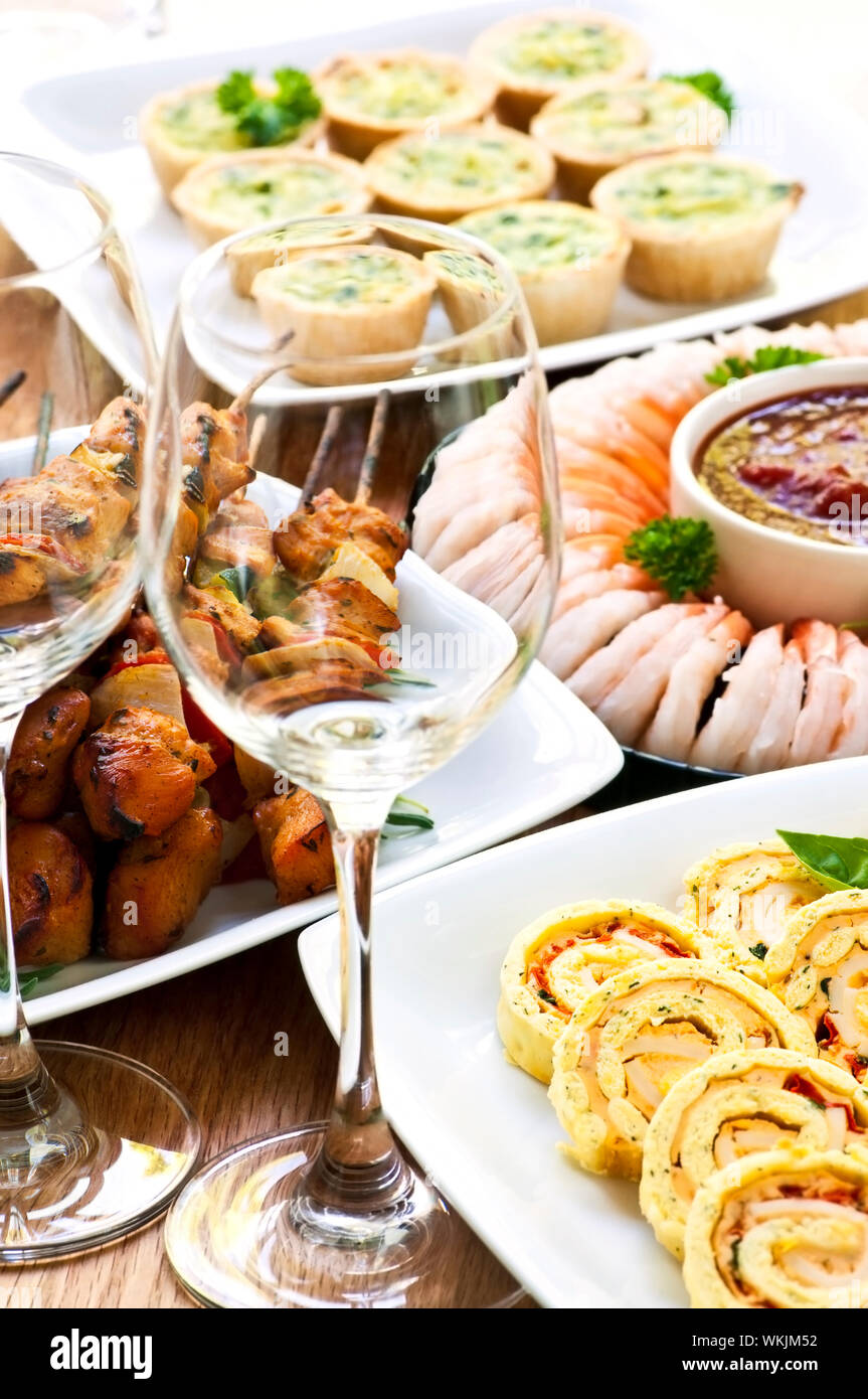 Many dishes of bite size appetizers and party food Stock Photo - Alamy