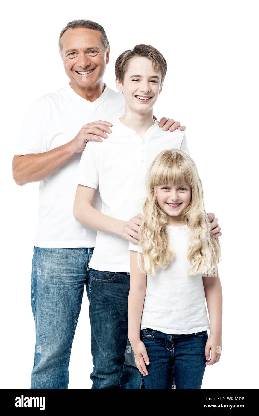 Smiling father, son and daughter in row, hands on shoulder Stock Photo ...