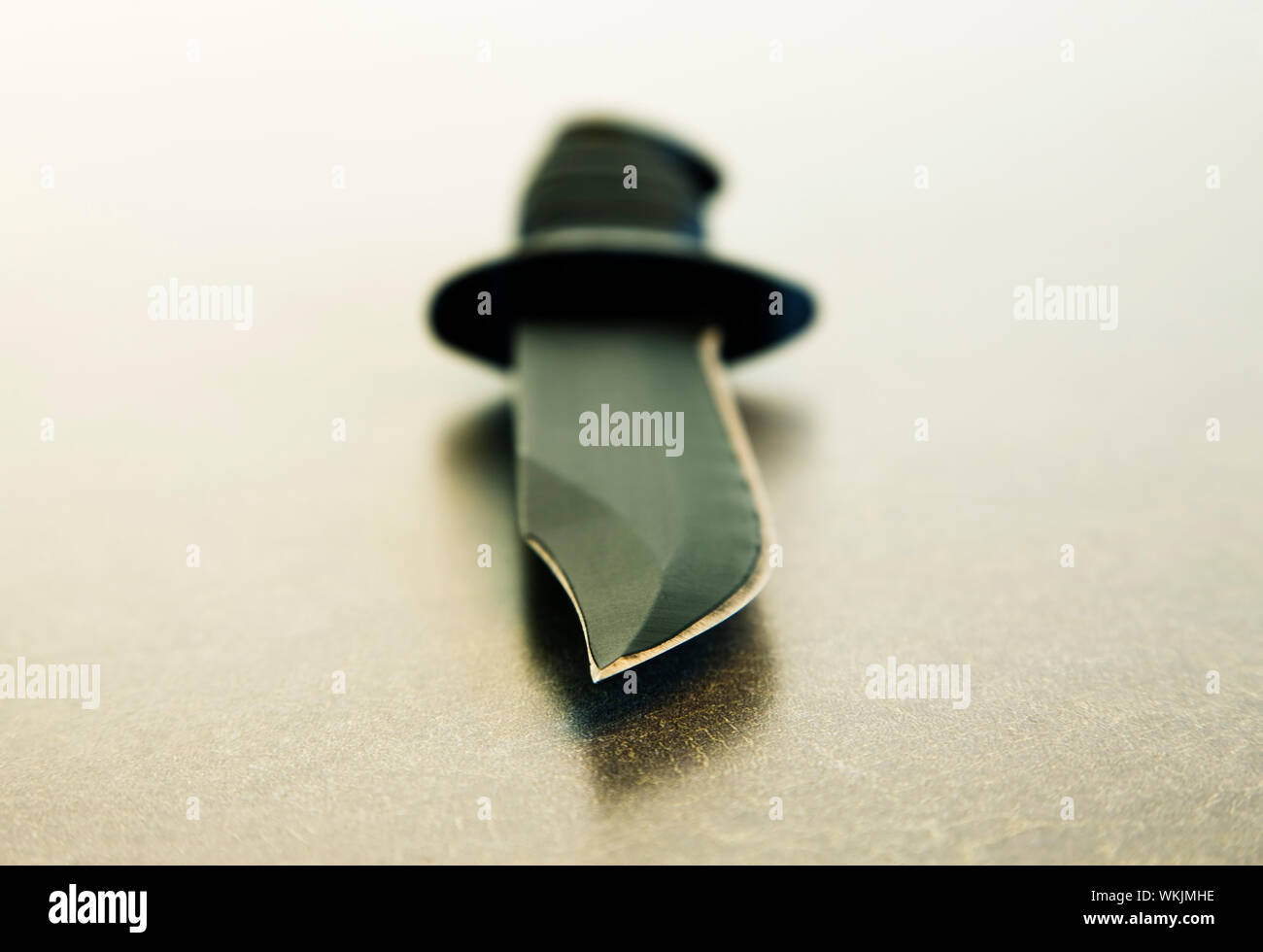 Tip of sharp knife blade on tabletop Stock Photo - Alamy