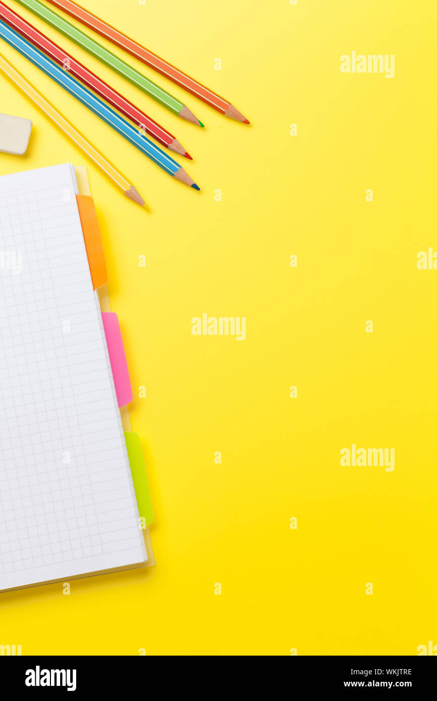 Office yellow workplace backdrop with notepad and colorful pencils ...